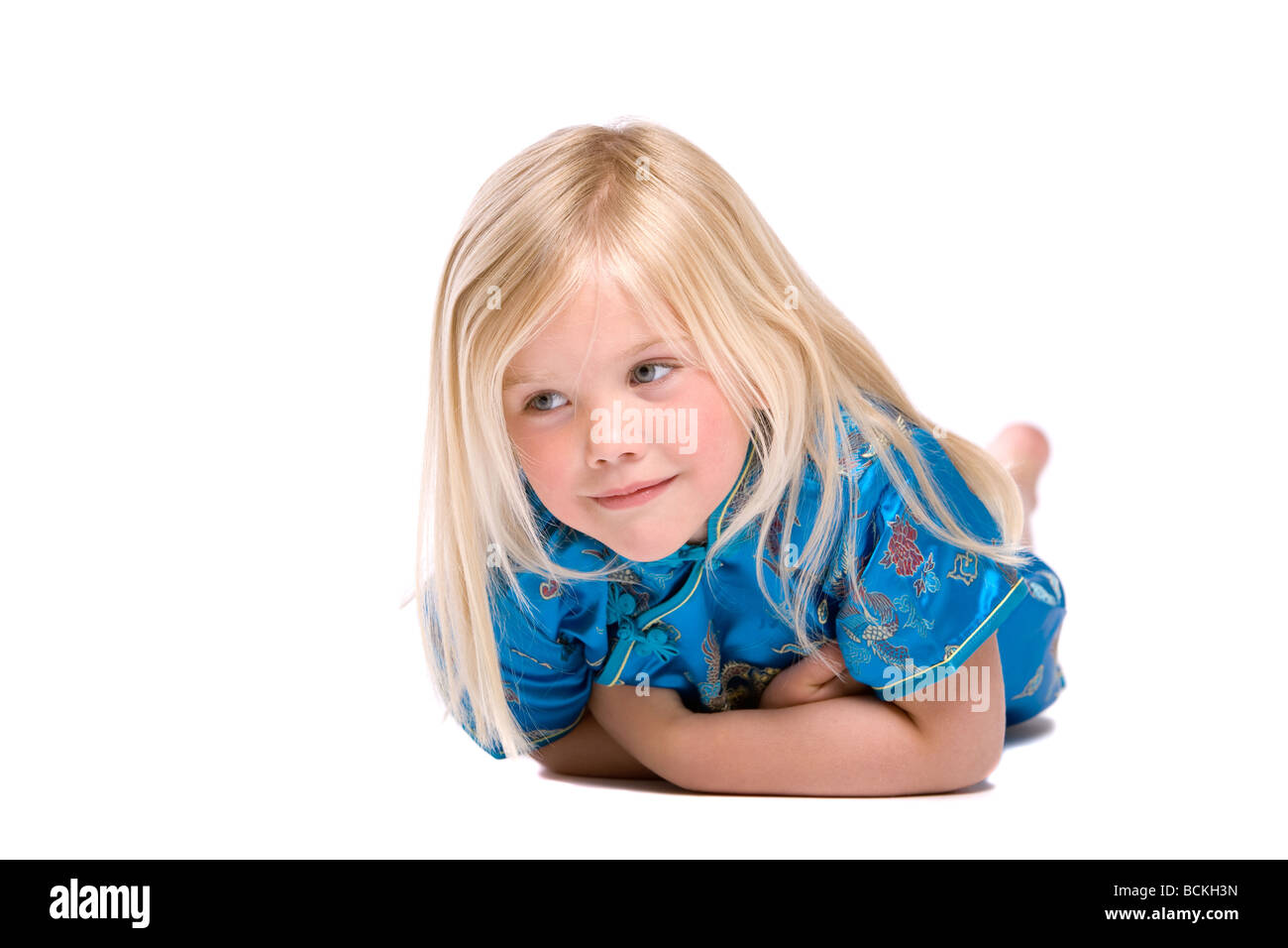 Cute little four year old girl lying on the floor Stock Photo - Alamy