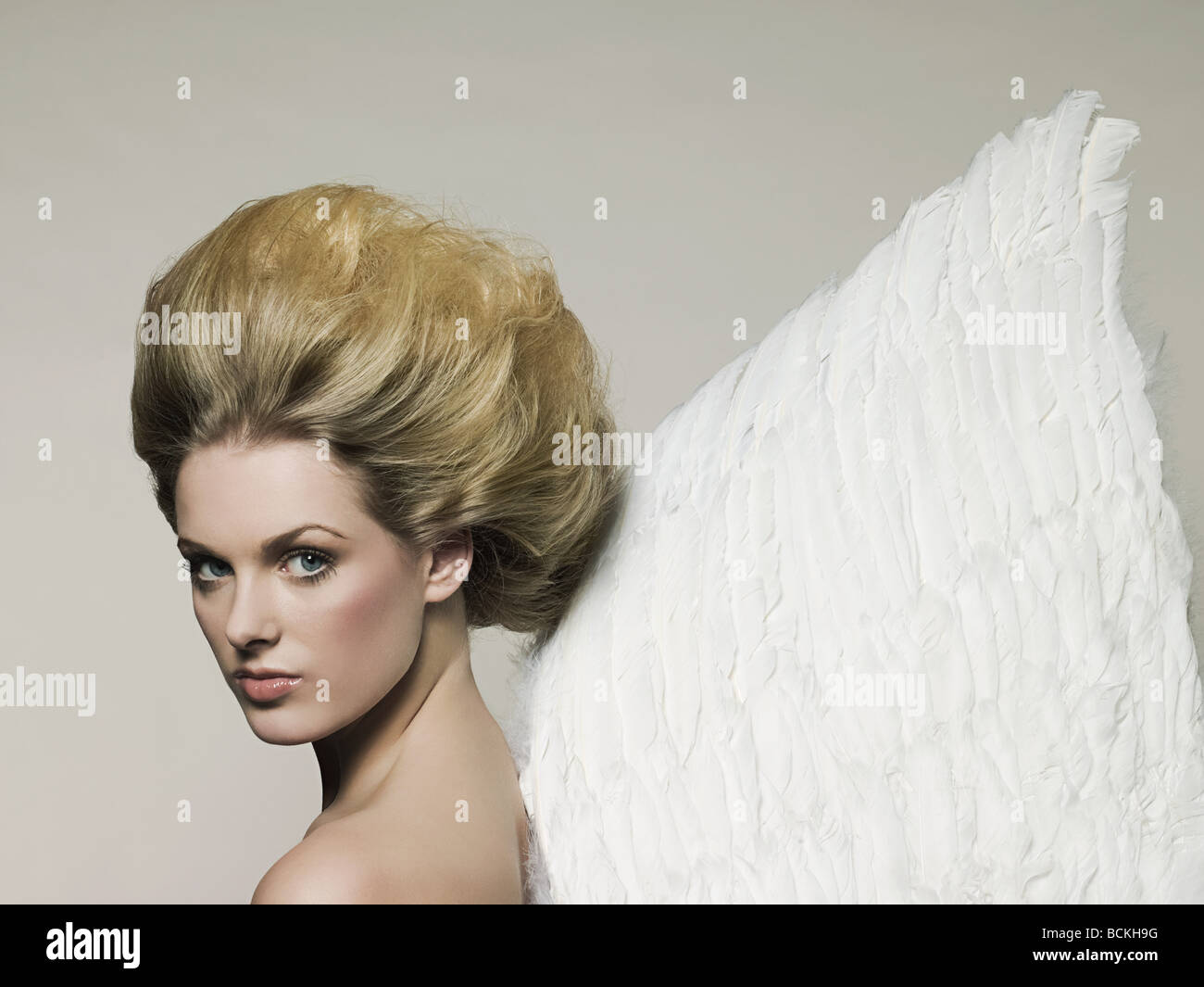 Young woman wearing angel wings Stock Photo - Alamy