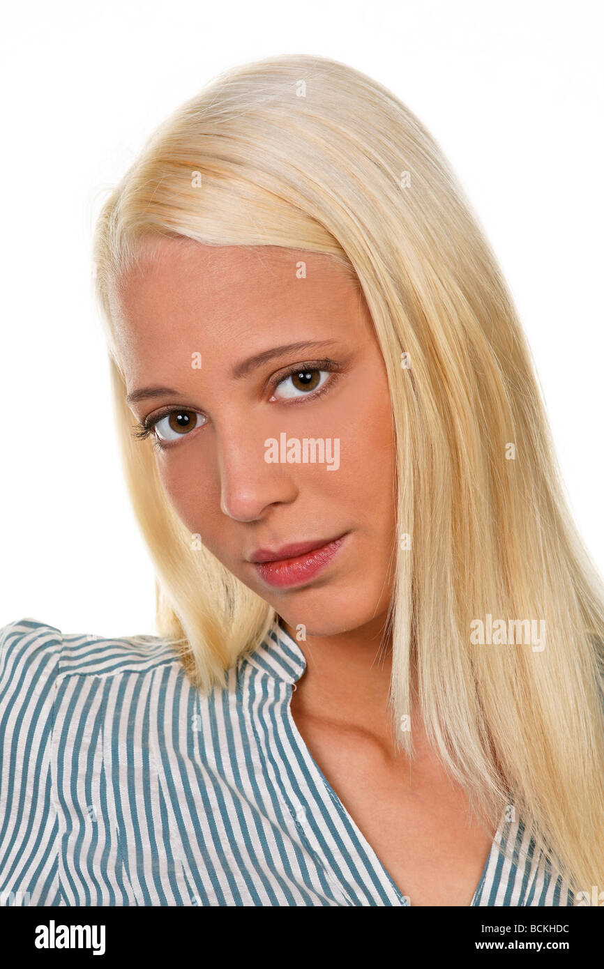 Young woman smiling seriously with a shy facial expression Stock Photo ...