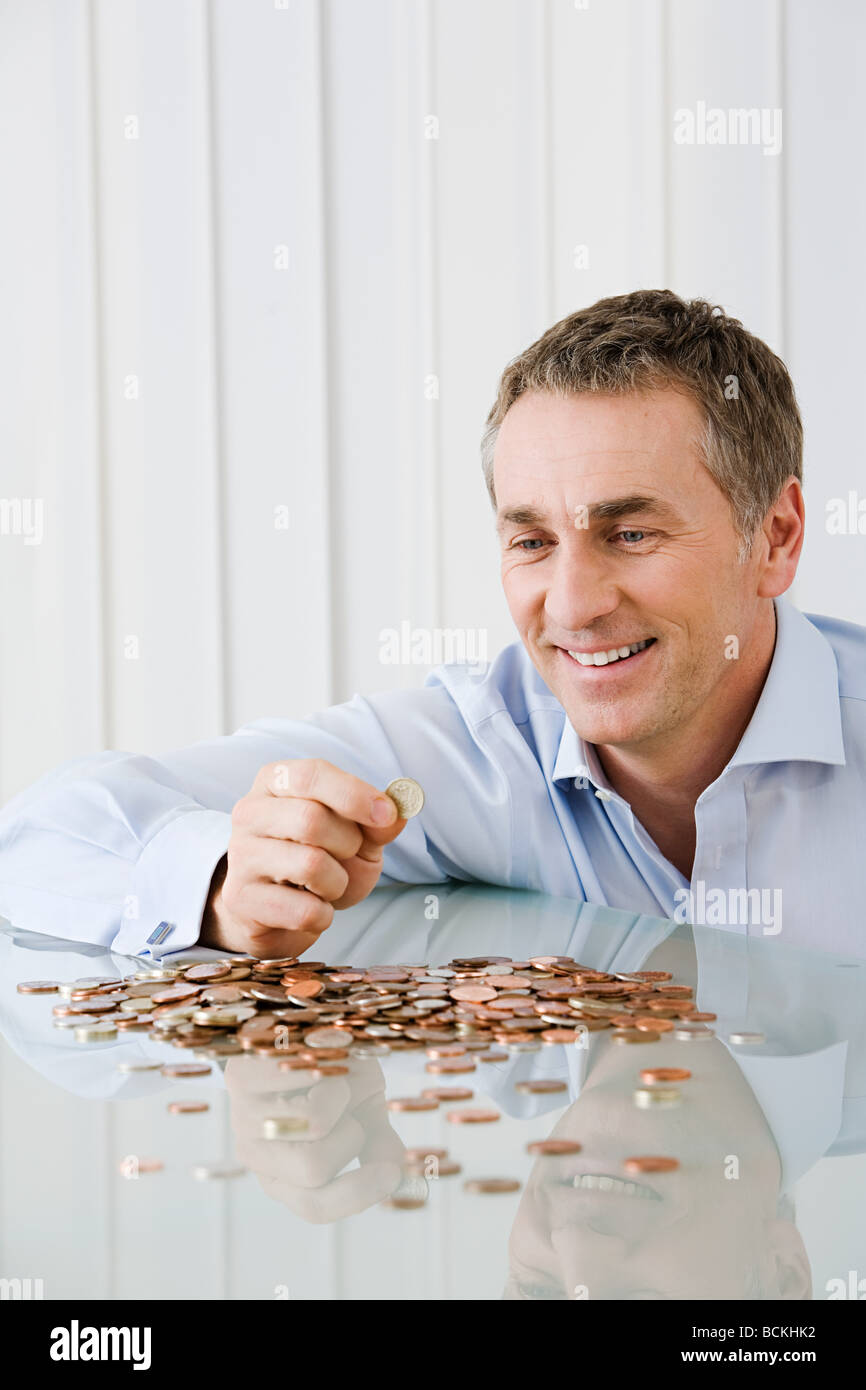 Man with coins Stock Photo - Alamy