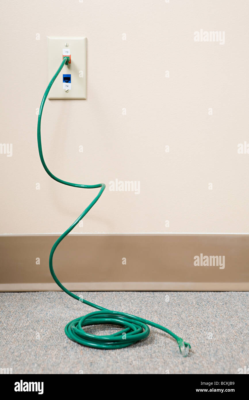 Power cable coming out of socket Stock Photo - Alamy