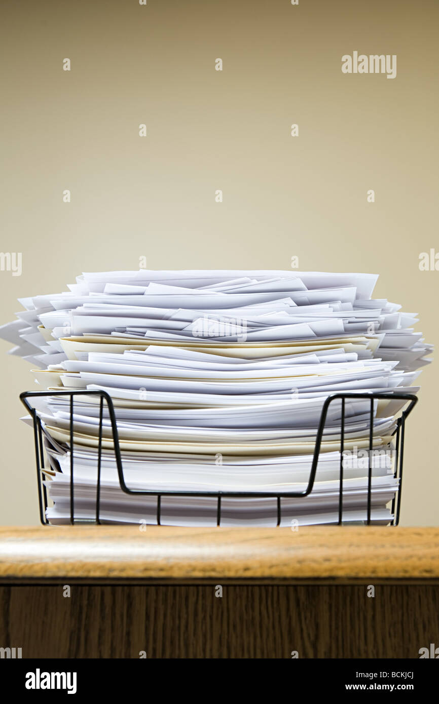 Overflowing paper inbox Stock Photo - Alamy