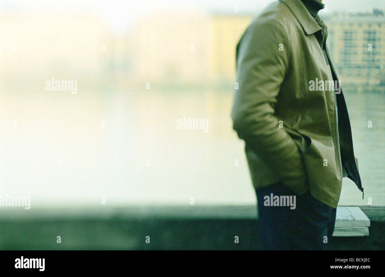 Man standing in front of river, mid-section Stock Photo - Alamy