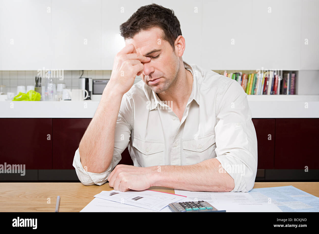 Stressed man with bills Stock Photo - Alamy