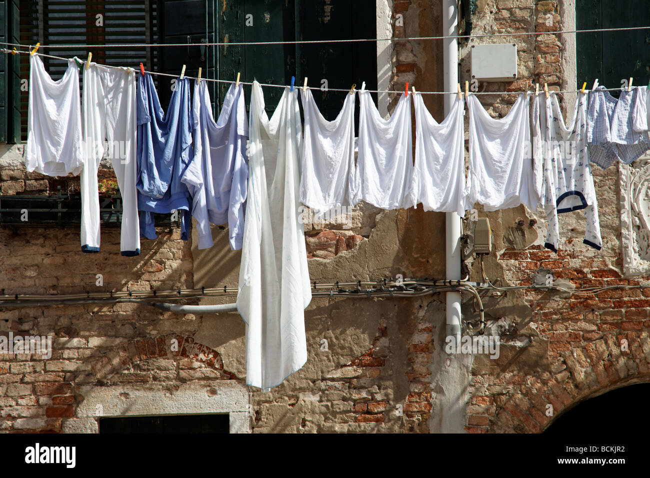 Drying laundry on a clothesline in an Italian court Stock Photo - Alamy