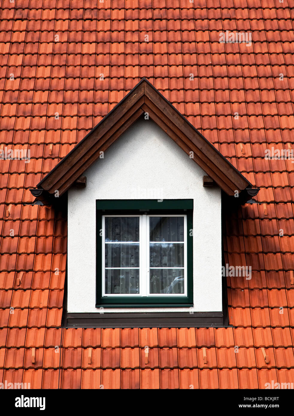 dormer with transom window in a tile-covered roof Stock Photo - Alamy