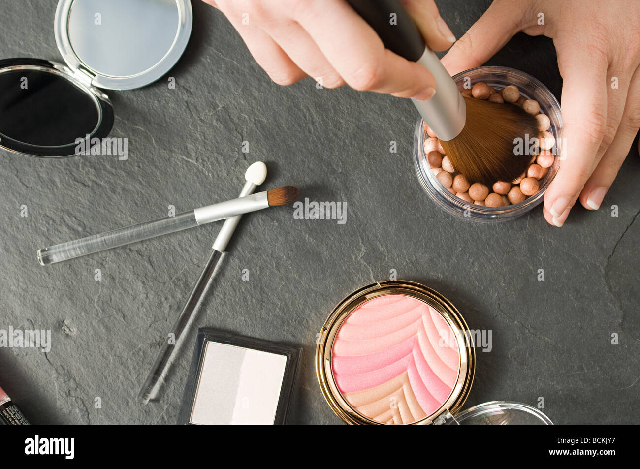 Woman using makeup Stock Photo - Alamy