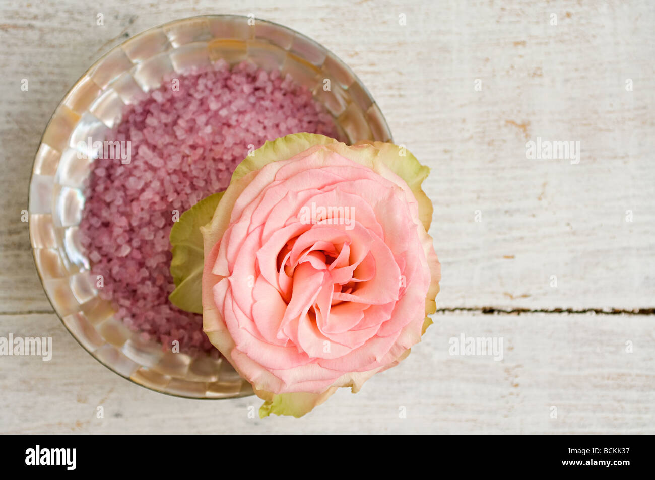 Rose and bowl of bath salts Stock Photo - Alamy