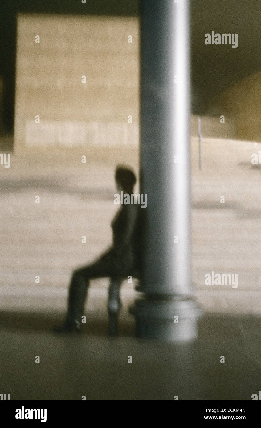 Person leaning against column Stock Photo - Alamy