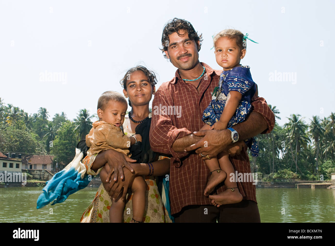 Indian family by communal baths Stock Photo - Alamy