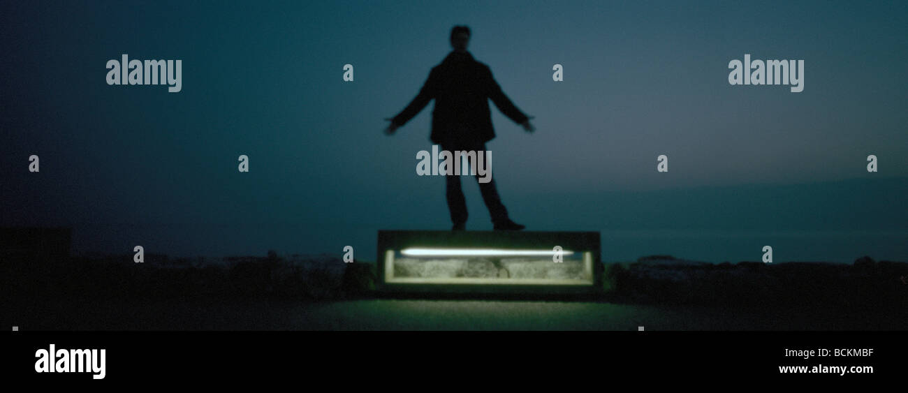 Man standing on bench at night, panoramic view Stock Photo - Alamy