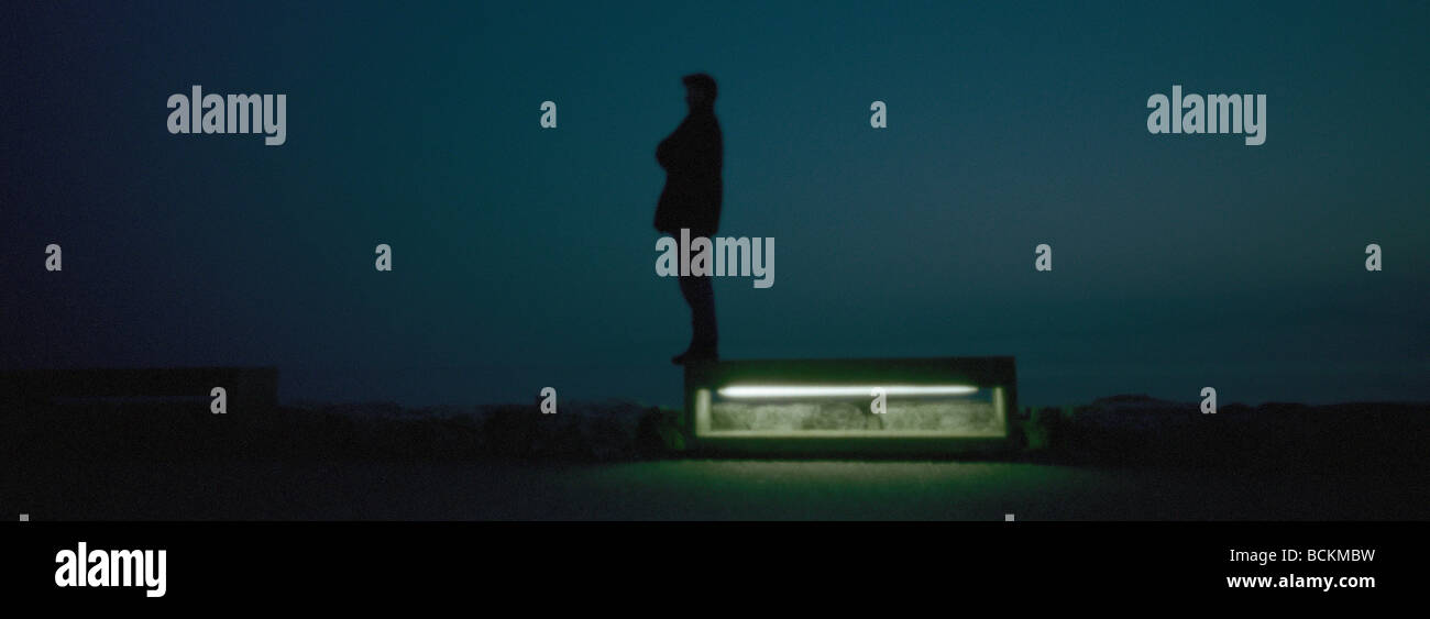 Man standing on bench at night, panoramic view Stock Photo - Alamy