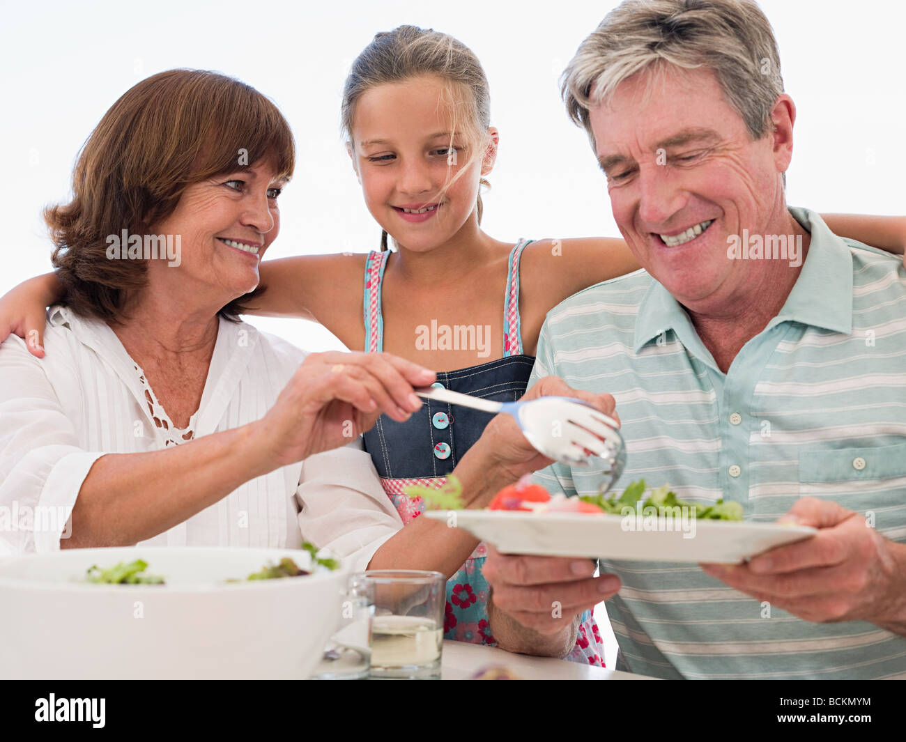 Three generation family around dining table hi-res stock photography ...