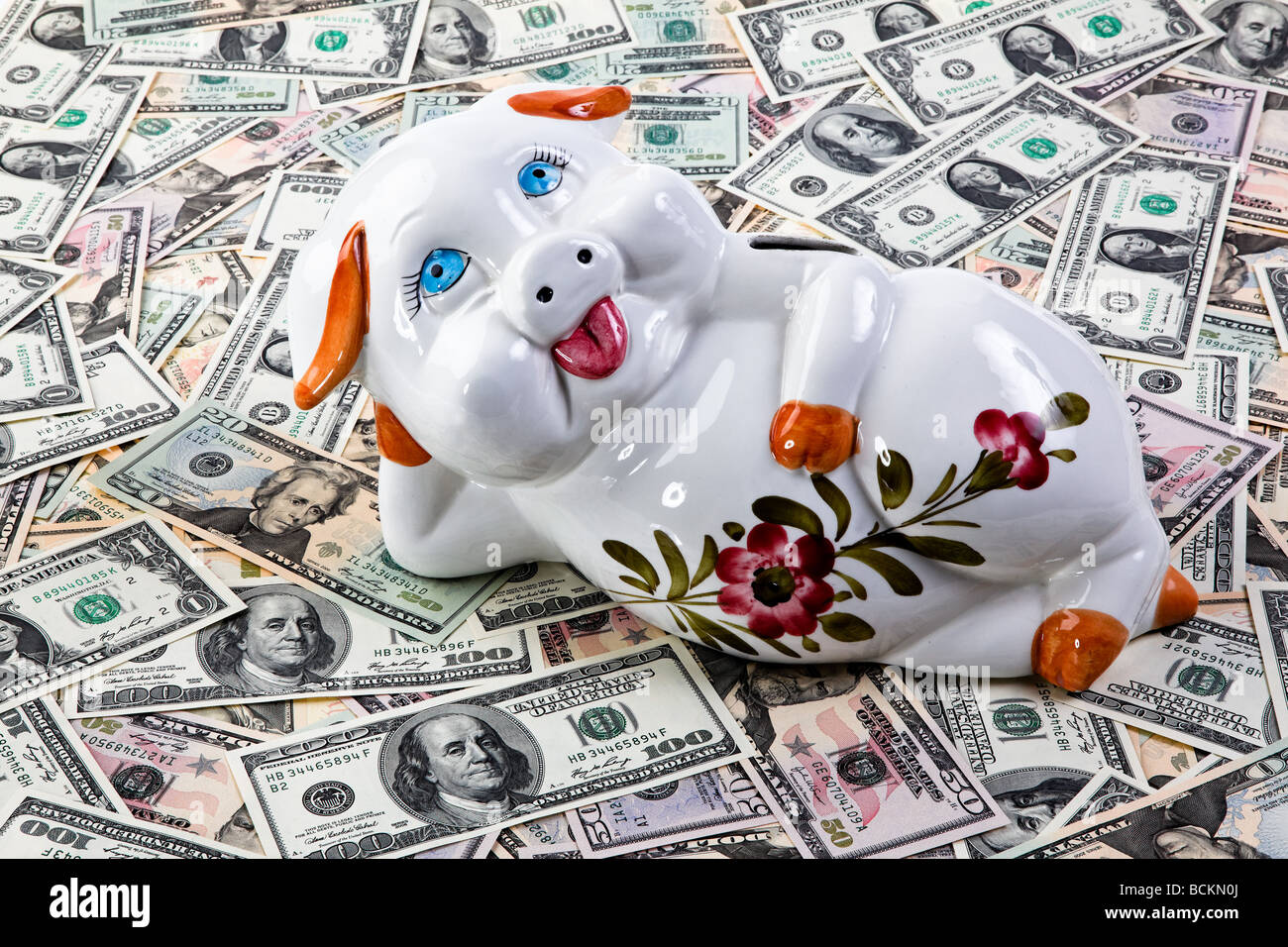 A piggy bank and a variety of U.S. Dollars banknotes Stock Photo - Alamy