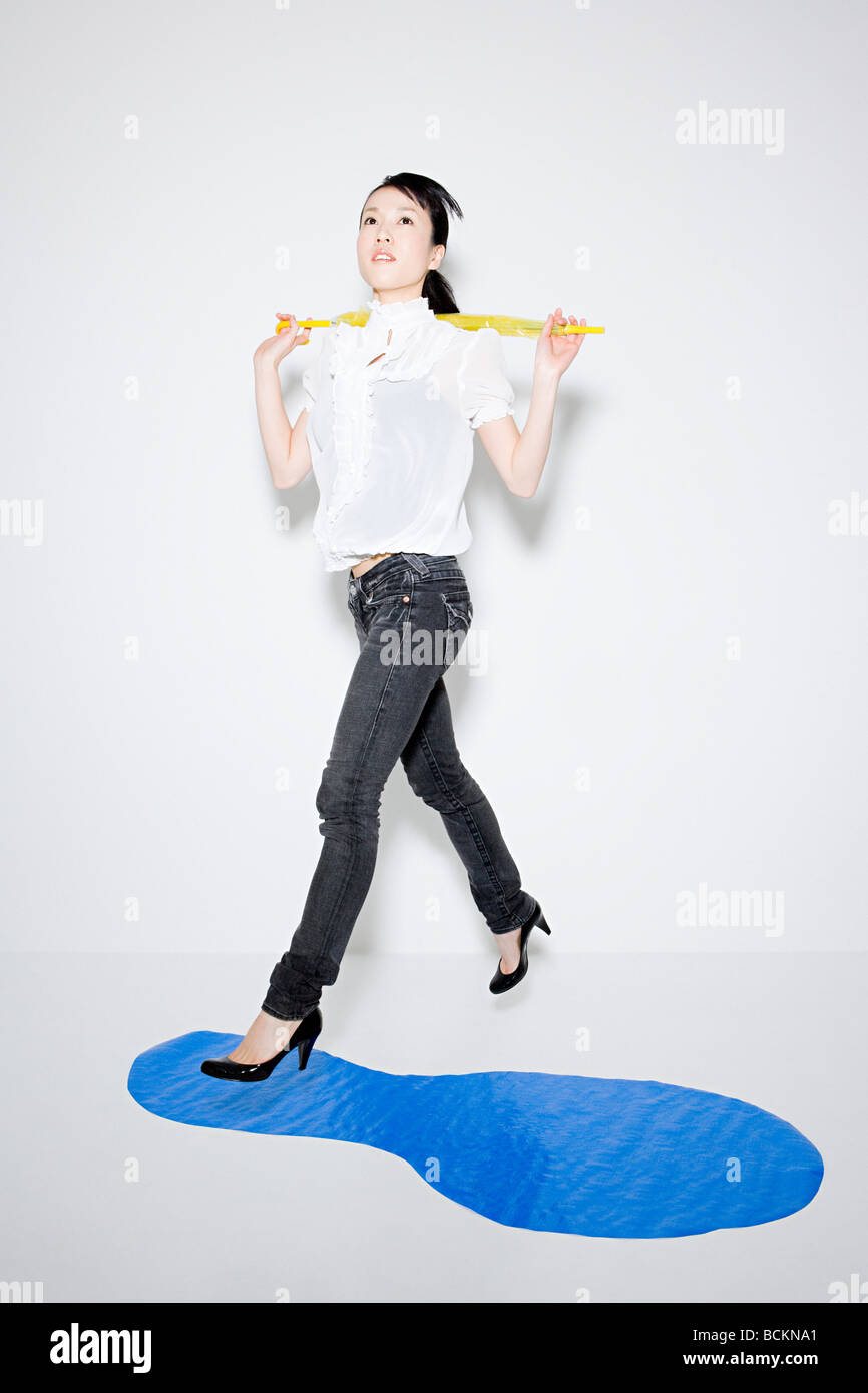 Woman jumping over puddle hi-res stock photography and images - Alamy