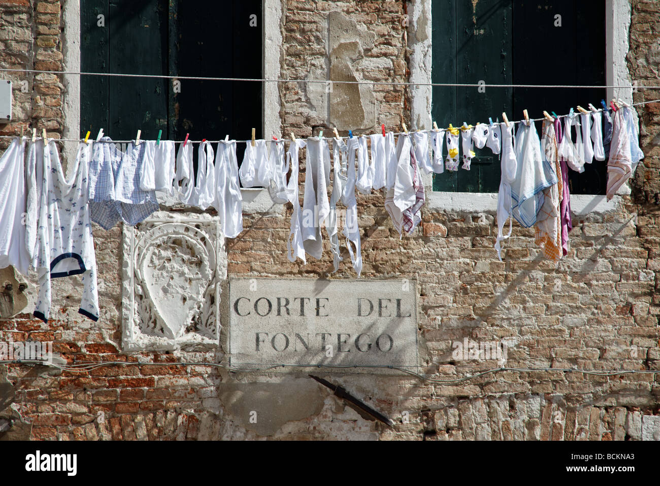 Drying laundry on a clothesline in an Italian court Stock Photo - Alamy