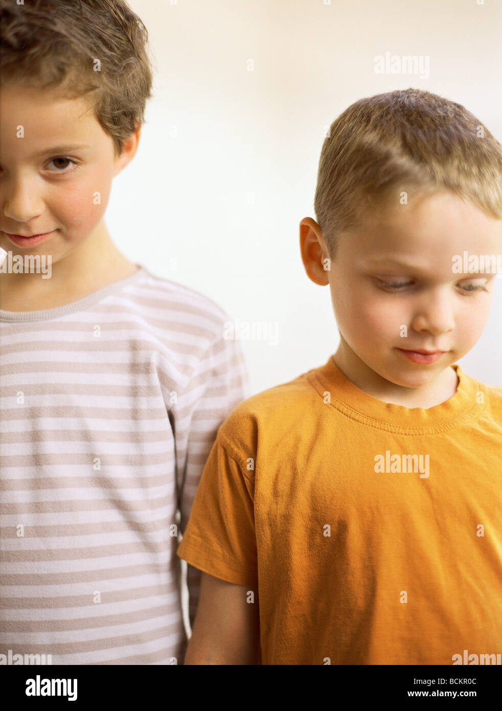 Two children standing side by side Stock Photo - Alamy