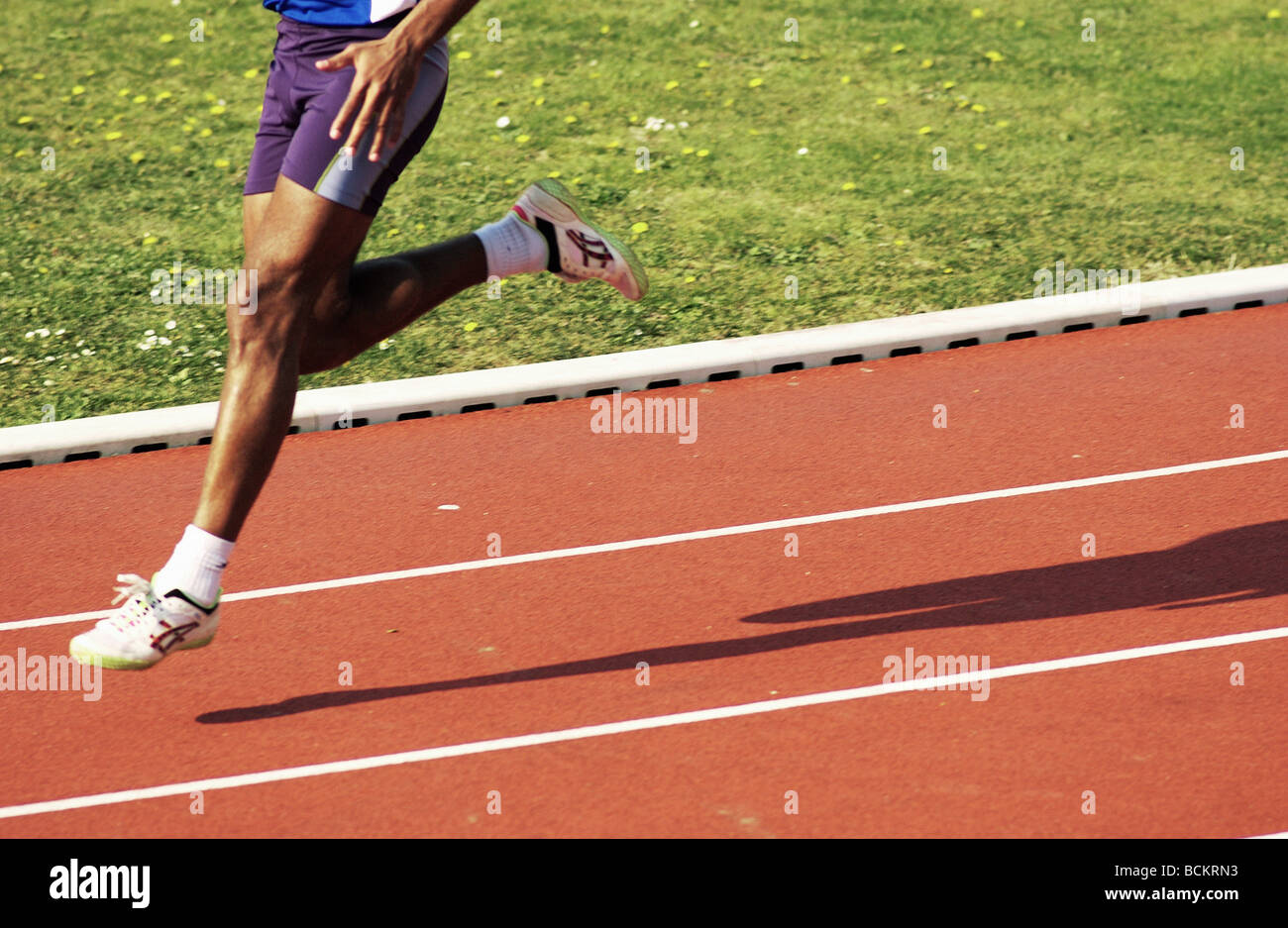 Runner on clay track Stock Photo - Alamy