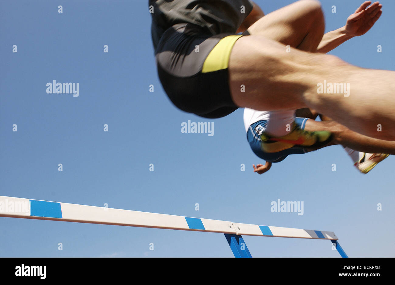 Athlete jumping hurdle, low angle view Stock Photo - Alamy