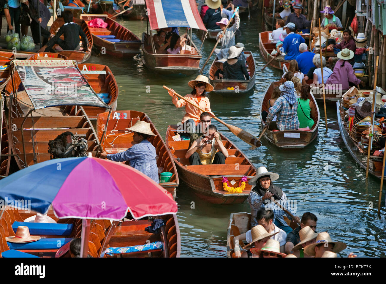 Thailand. A very busy canal, or khlong, at the bustling floating market ...
