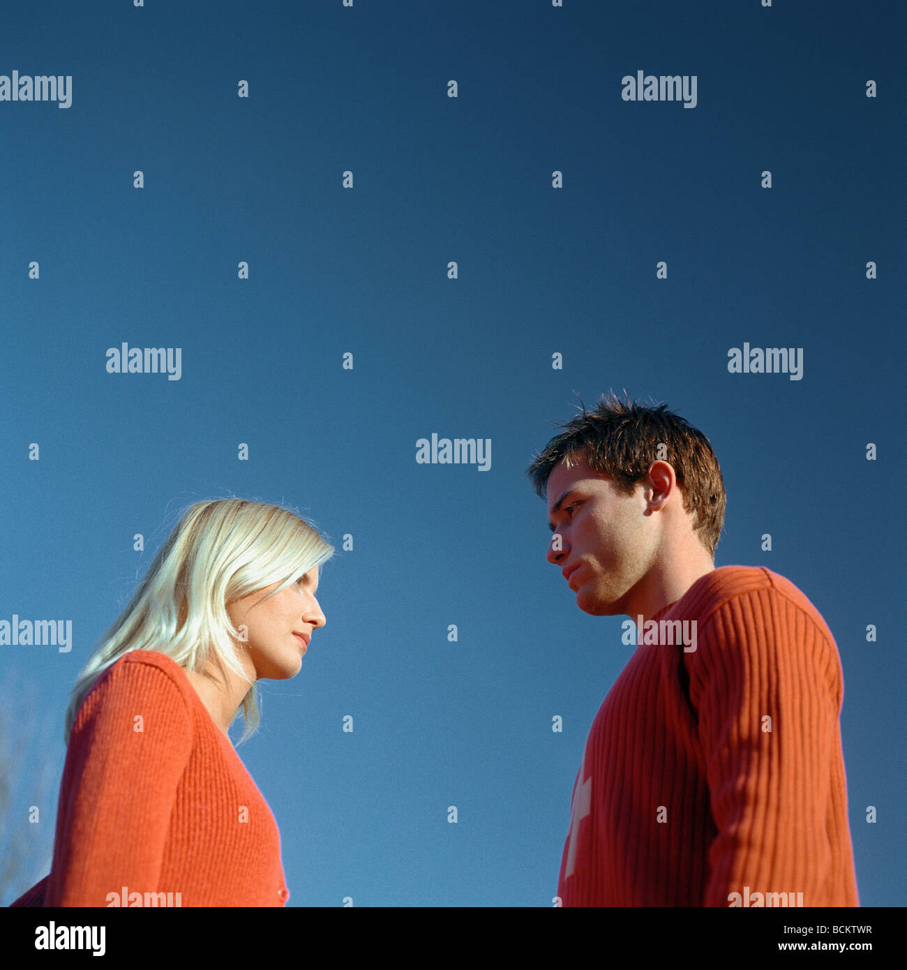 Man and woman standing face to face, low angle view Stock Photo - Alamy