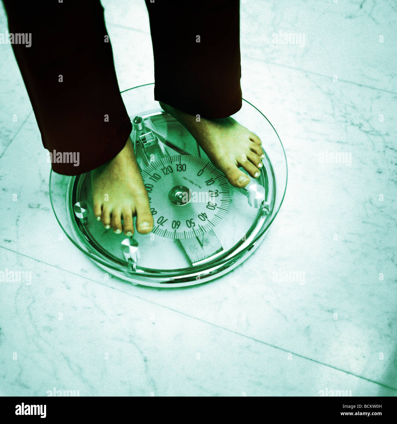 Woman standing on scale, lower section Stock Photo - Alamy