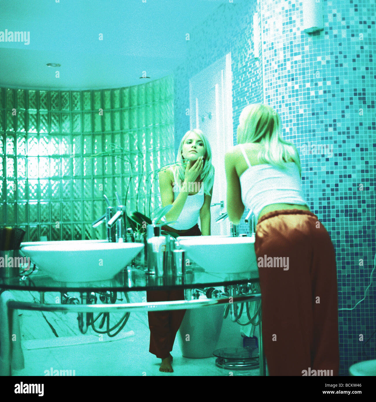 Woman leaning over sink looking hi-res stock photography and images - Alamy