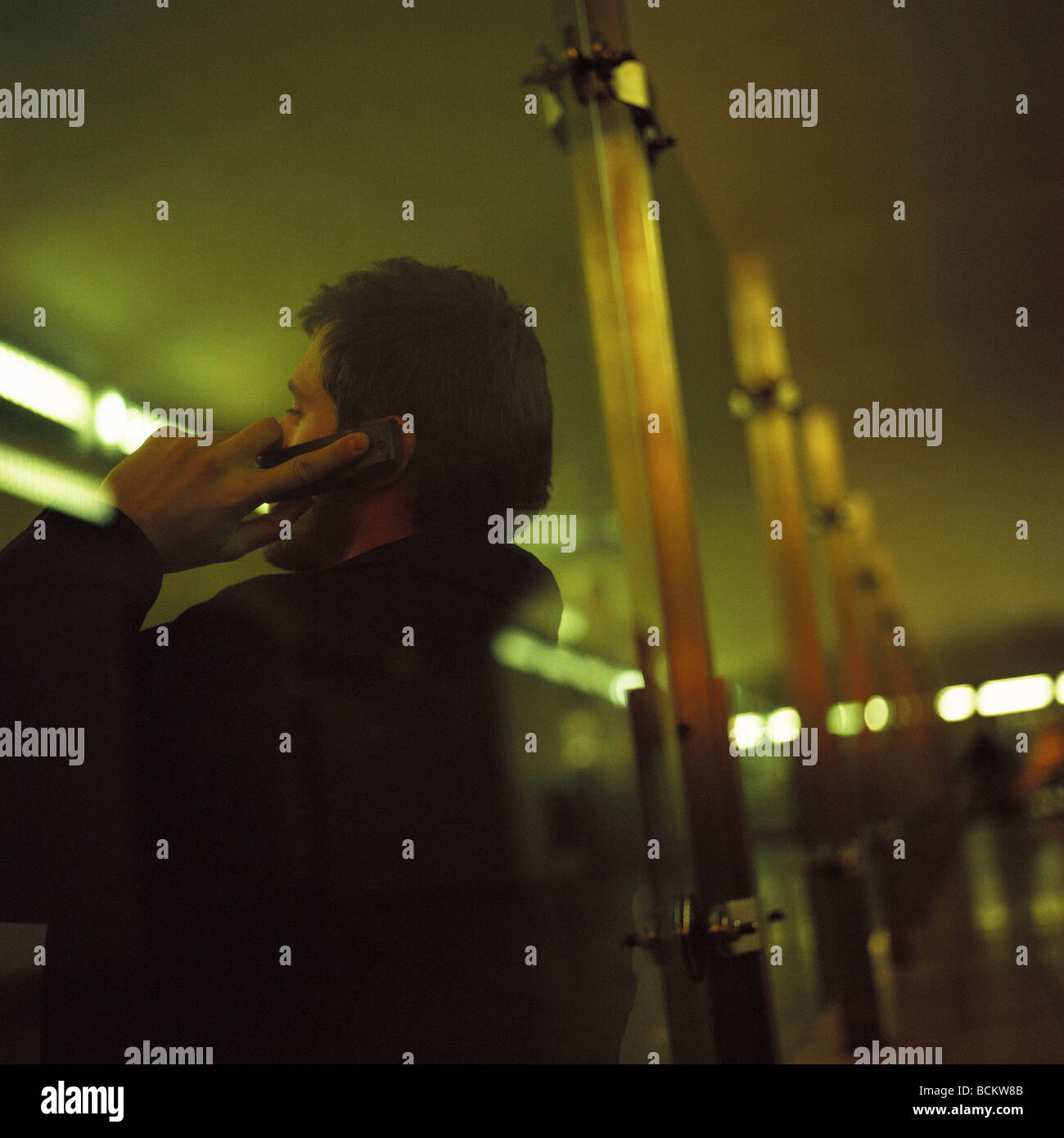 Man using cell phone, rear view Stock Photo - Alamy