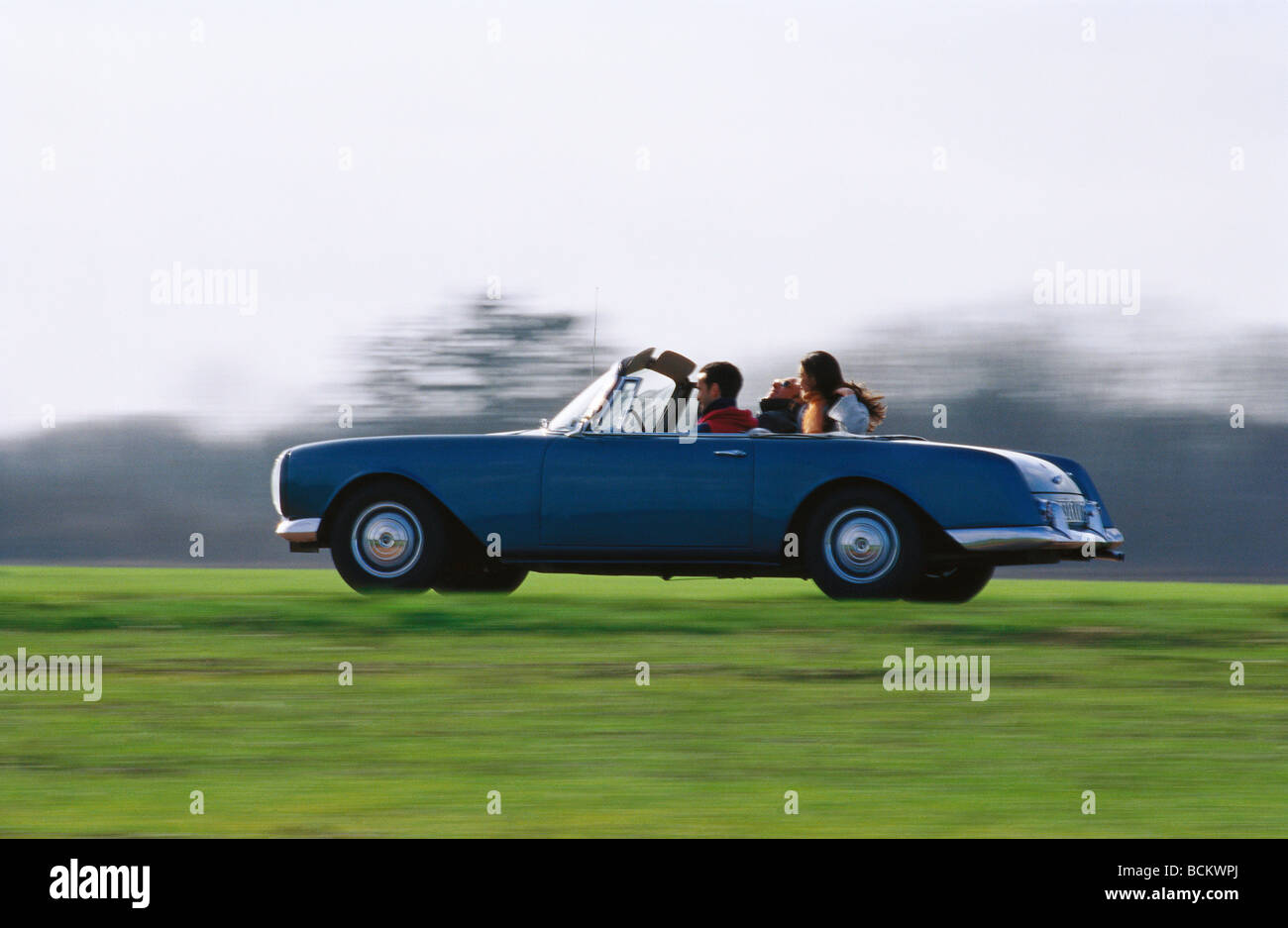 People riding in convertible car Stock Photo - Alamy