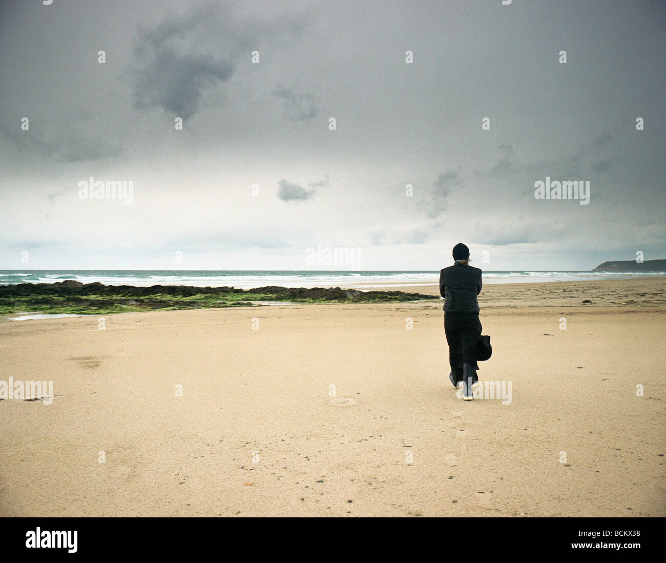 Person walking on beach, rear view Stock Photo - Alamy