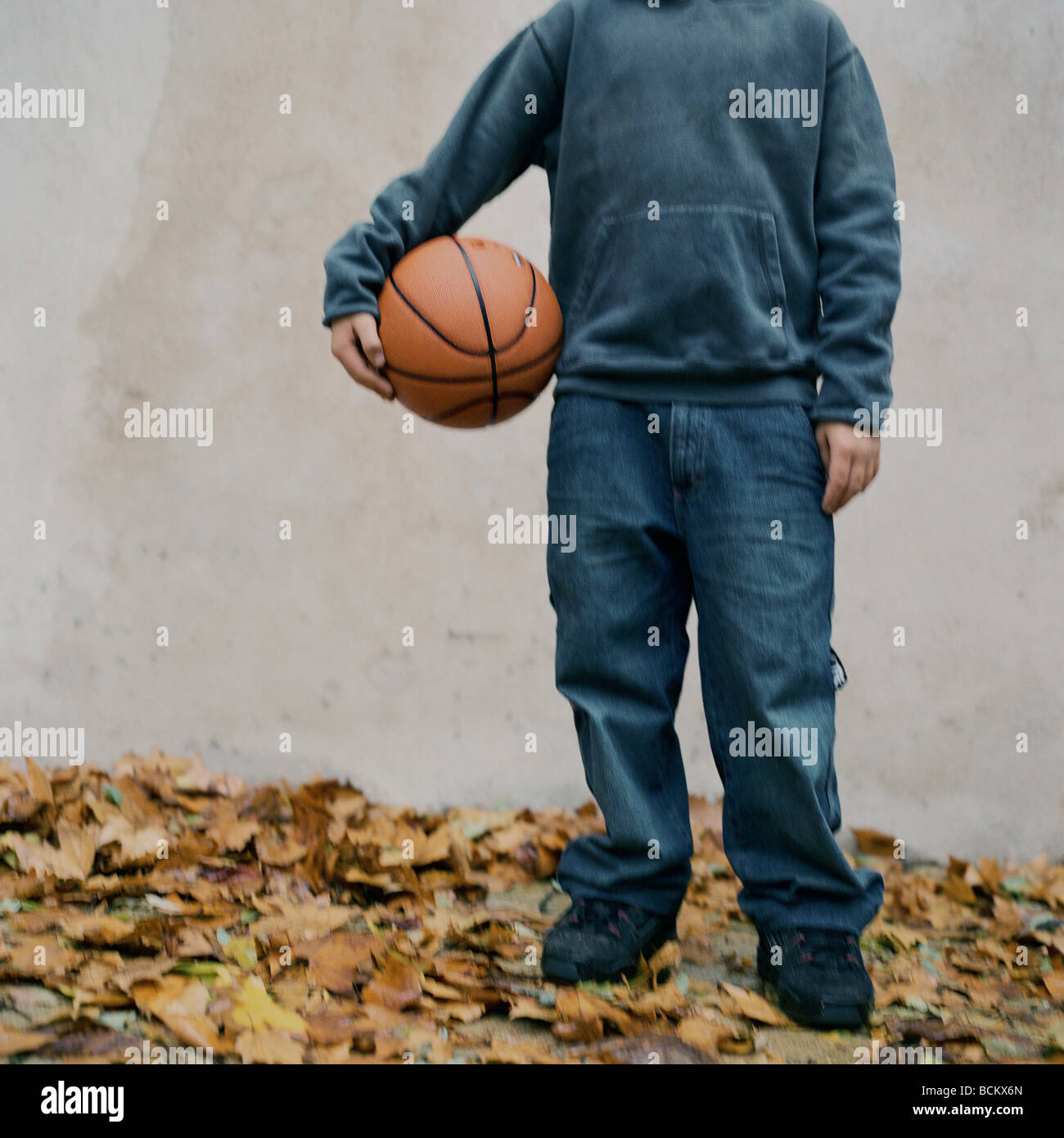 Boy holding basketball, neck down Stock Photo - Alamy