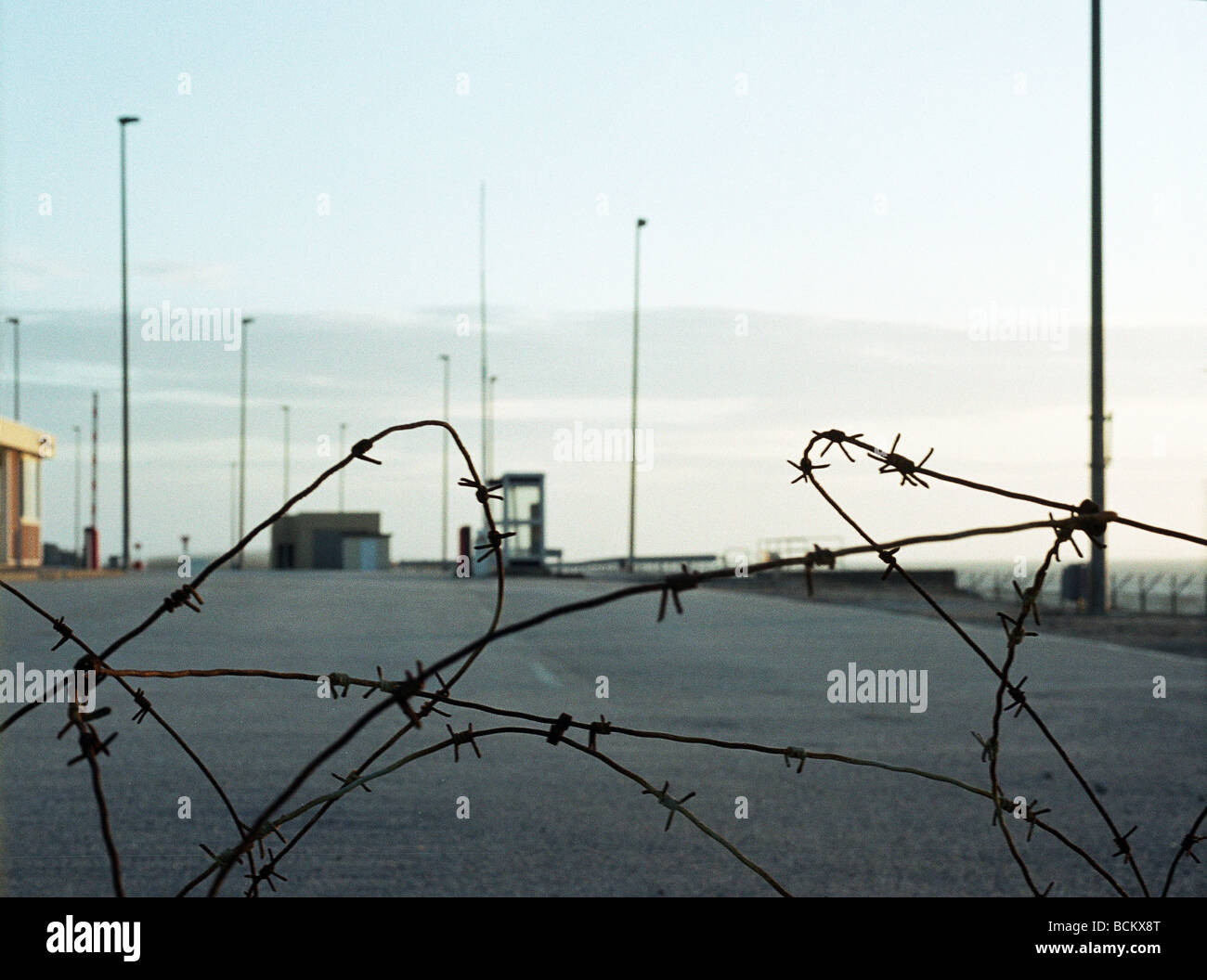 Barbed wire in front of parking lot Stock Photo - Alamy