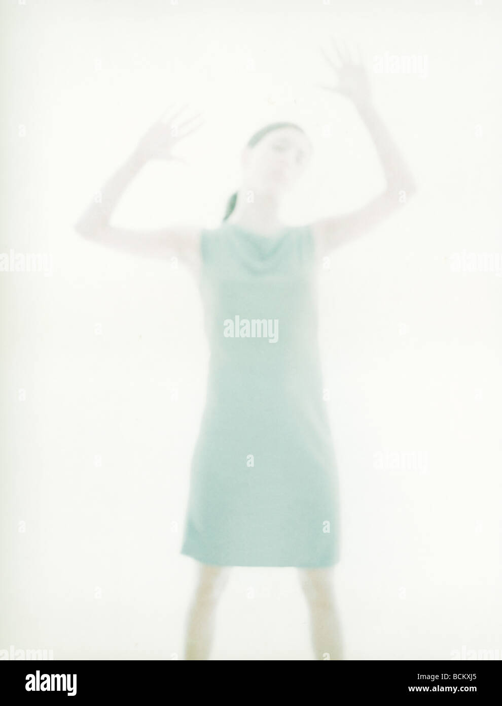 Woman standing with hands up Stock Photo - Alamy
