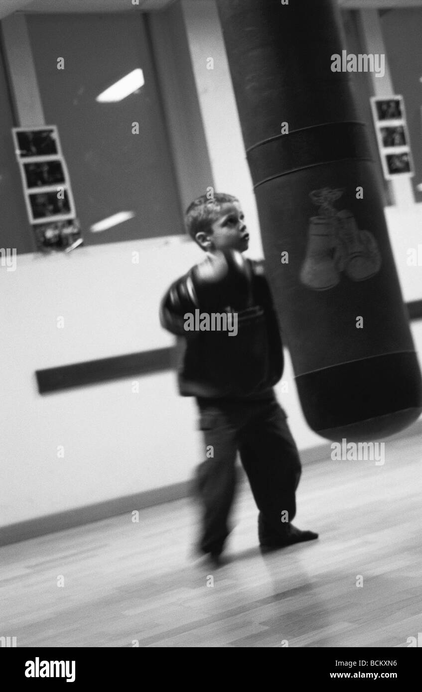 Boy punching punching bag, b&w Stock Photo - Alamy
