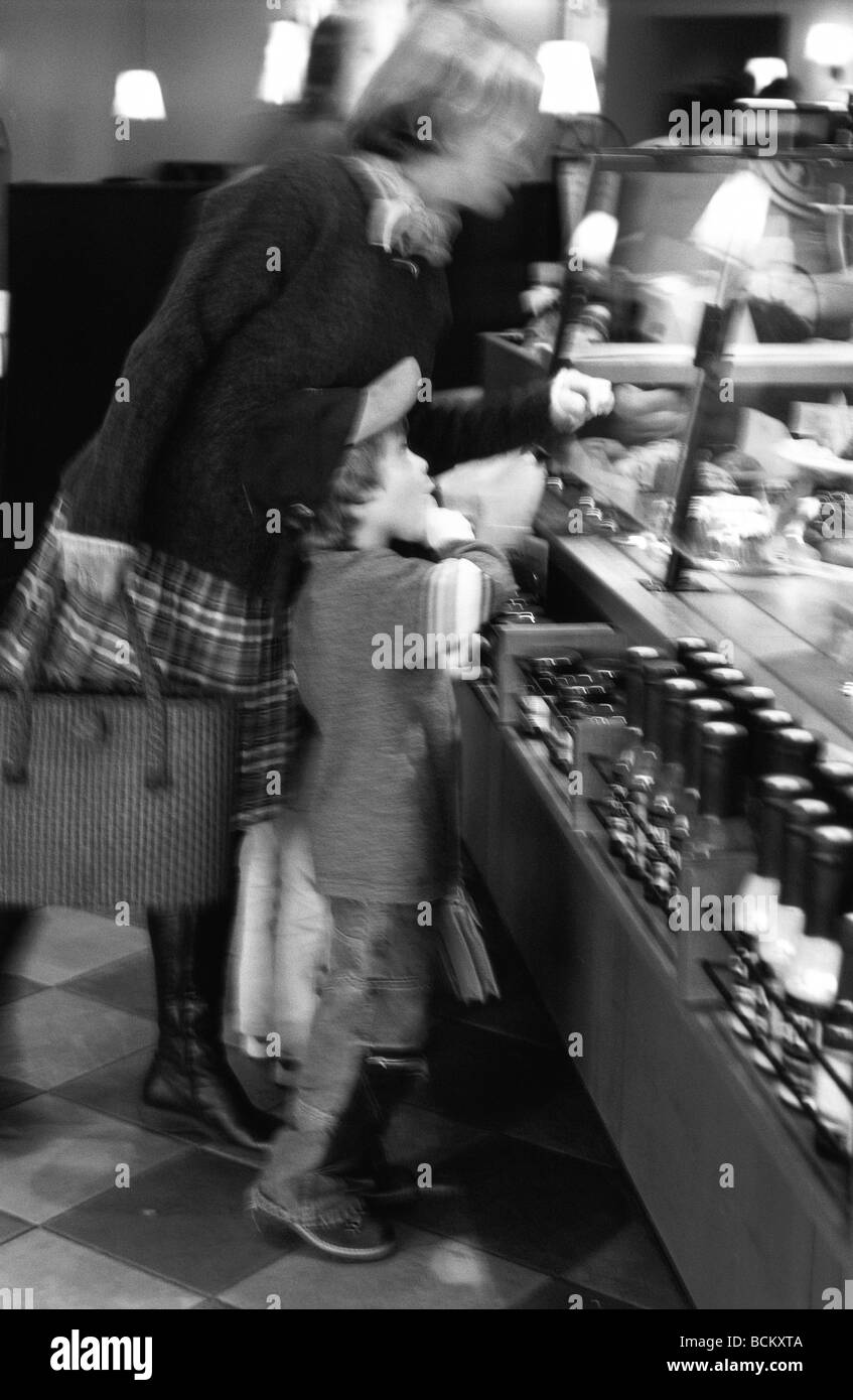 Woman and child standing at counter in cafeteria, b&w Stock Photo - Alamy