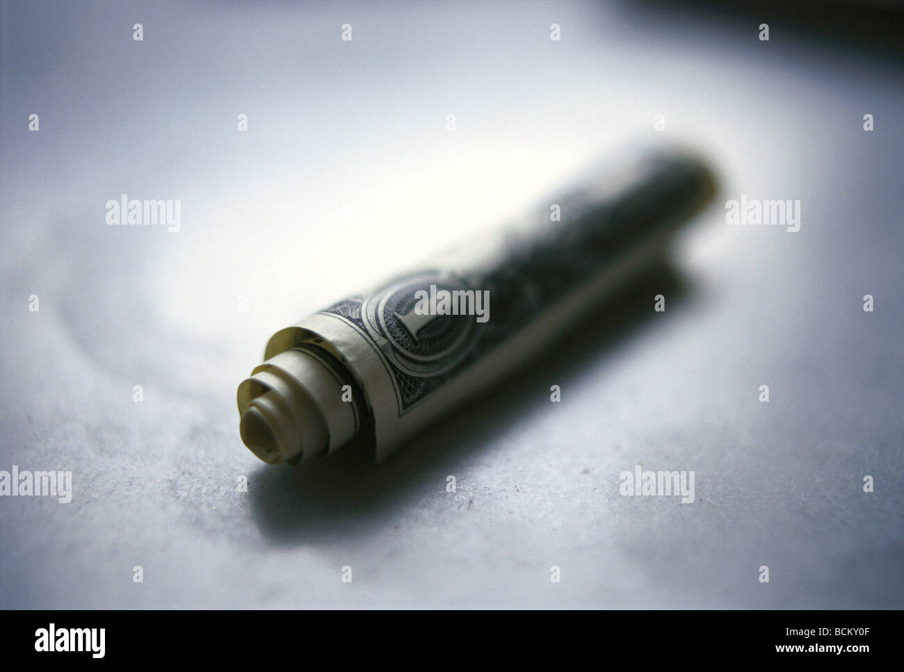 Rolled up dollar bill Stock Photo - Alamy