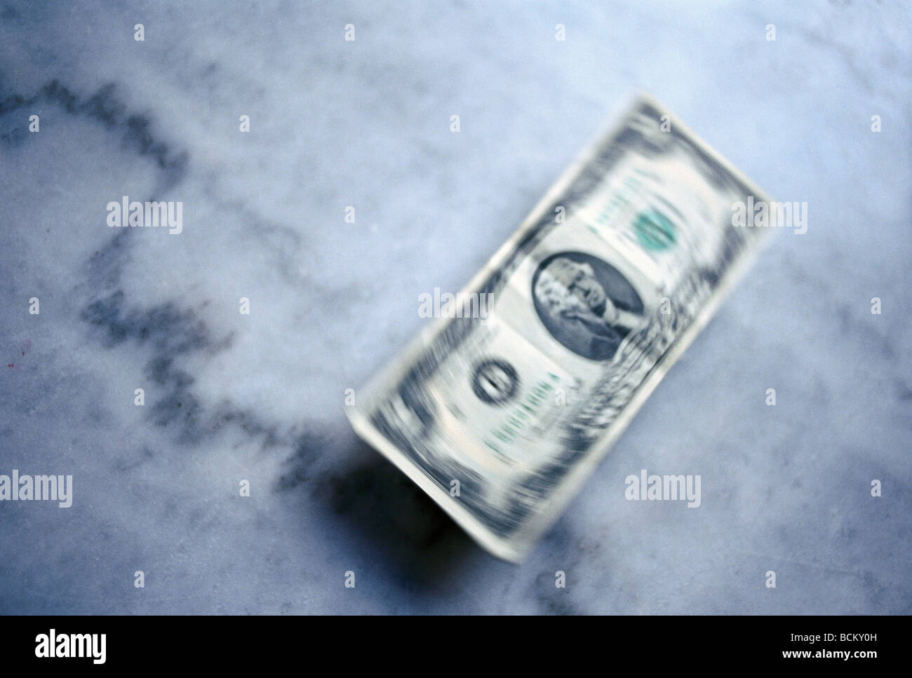 Two dollar bill on floor, blurred motion Stock Photo - Alamy