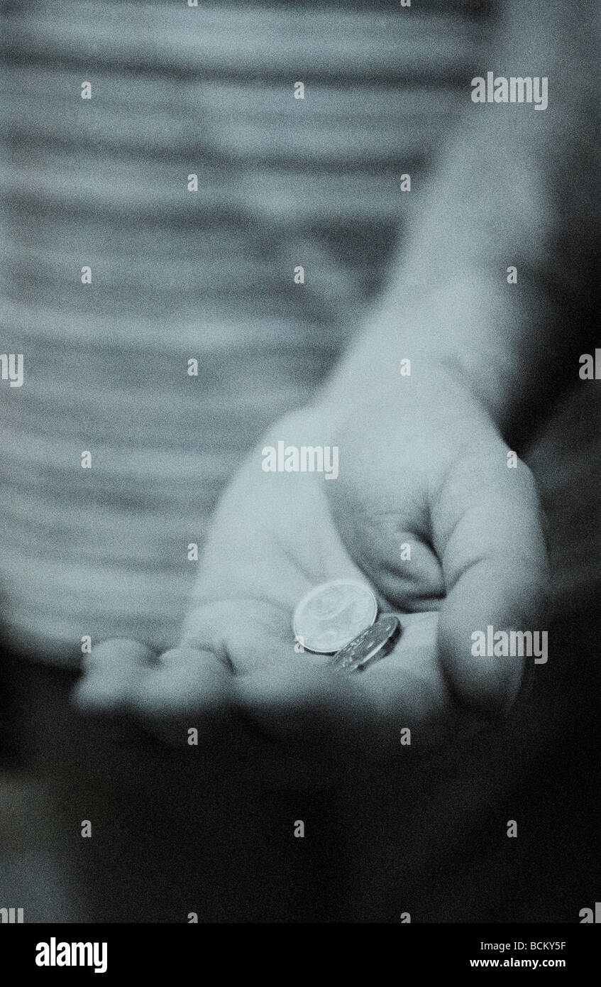 Hand holding change Stock Photo - Alamy