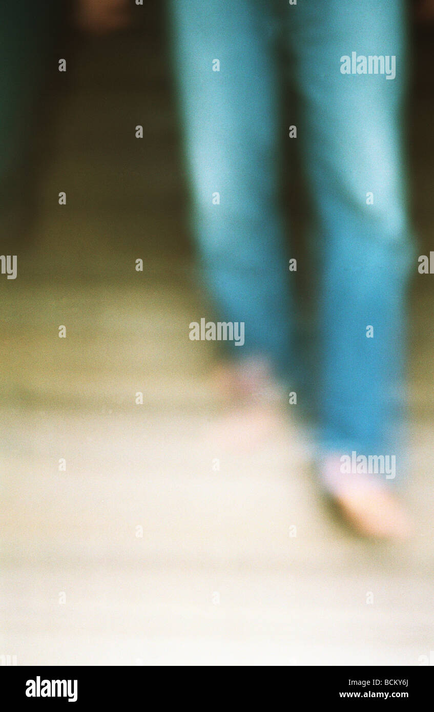 Barefoot person walking downstairs, lower section, defocused Stock ...