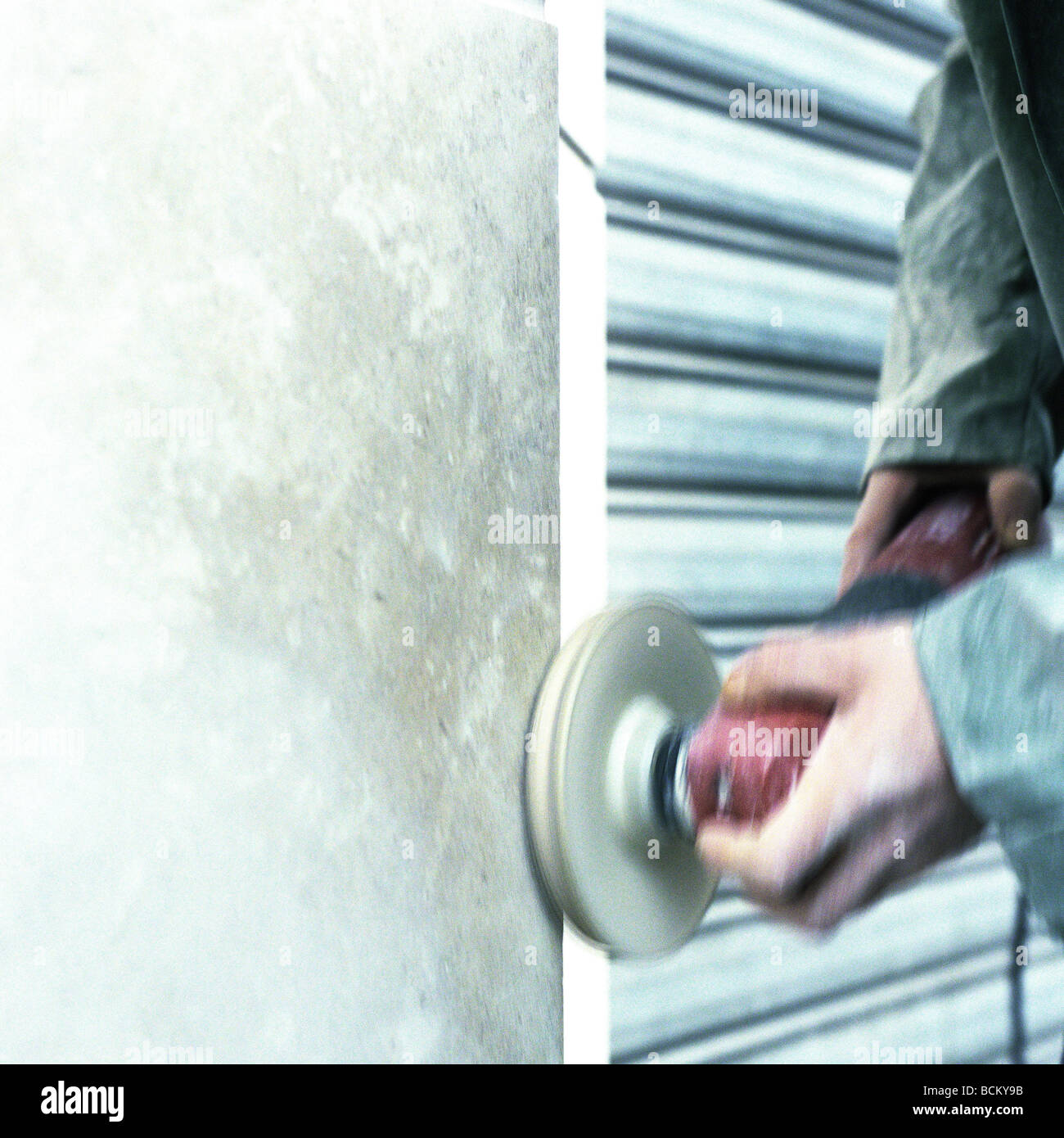 Person sanding wall Stock Photo - Alamy