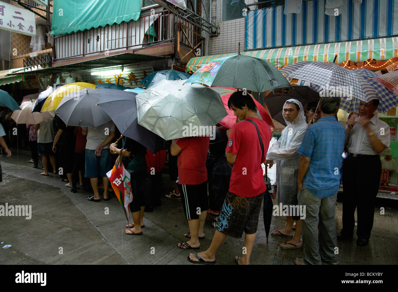 China Hong Kong people queue up in the rain to withdraw money from a ...
