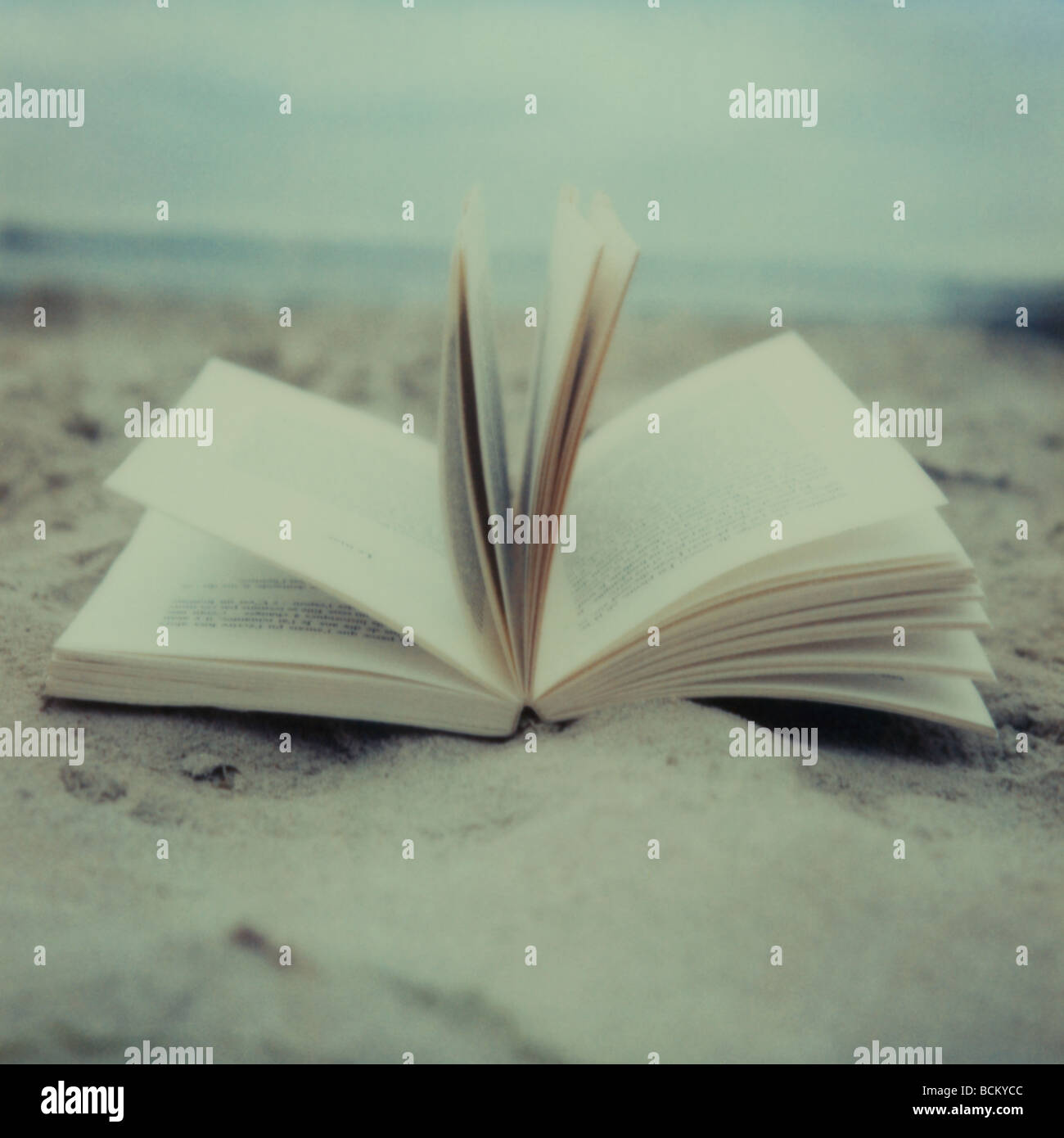 Book open on sand Stock Photo - Alamy