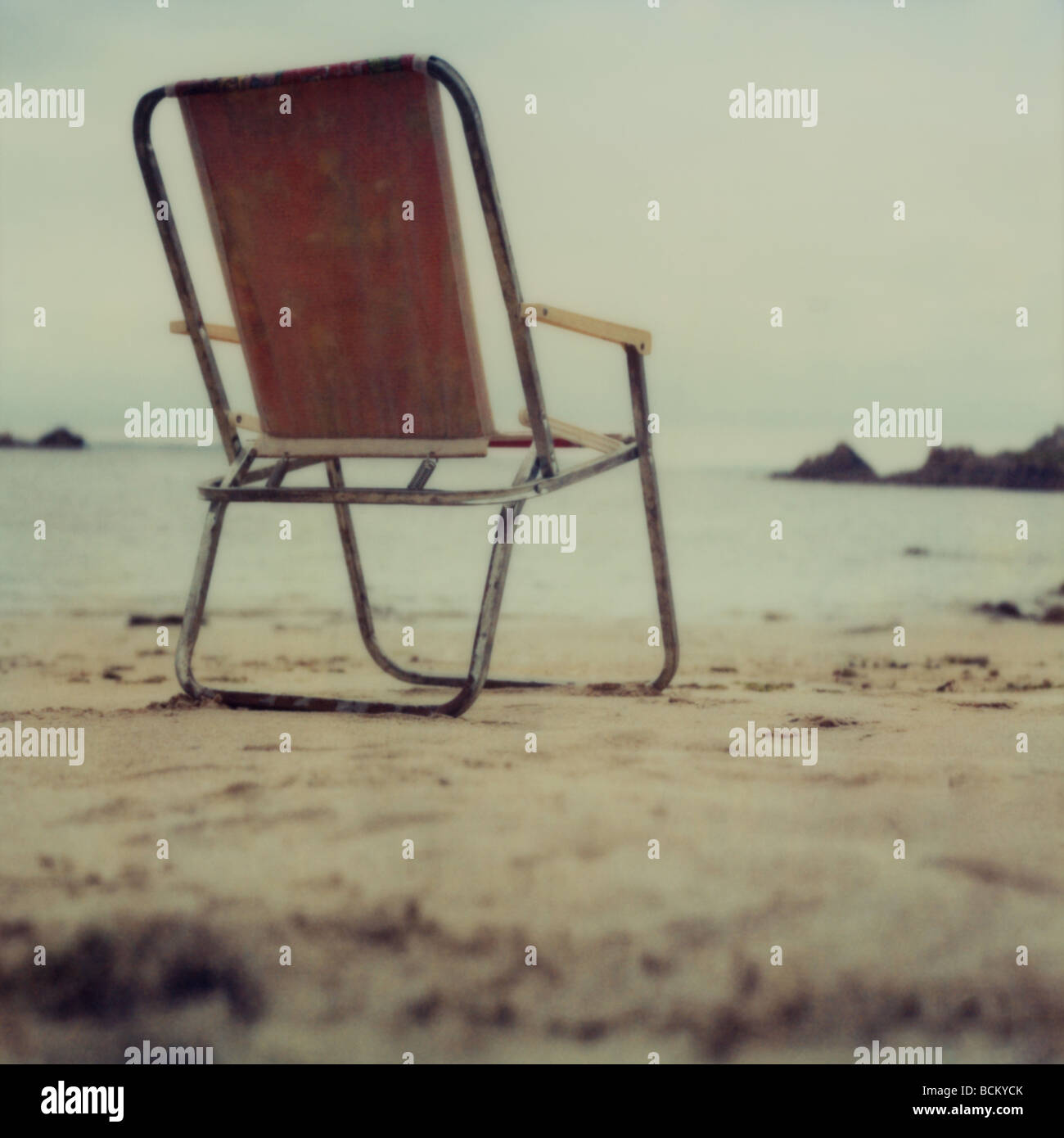 Folding chair on sand Stock Photo - Alamy