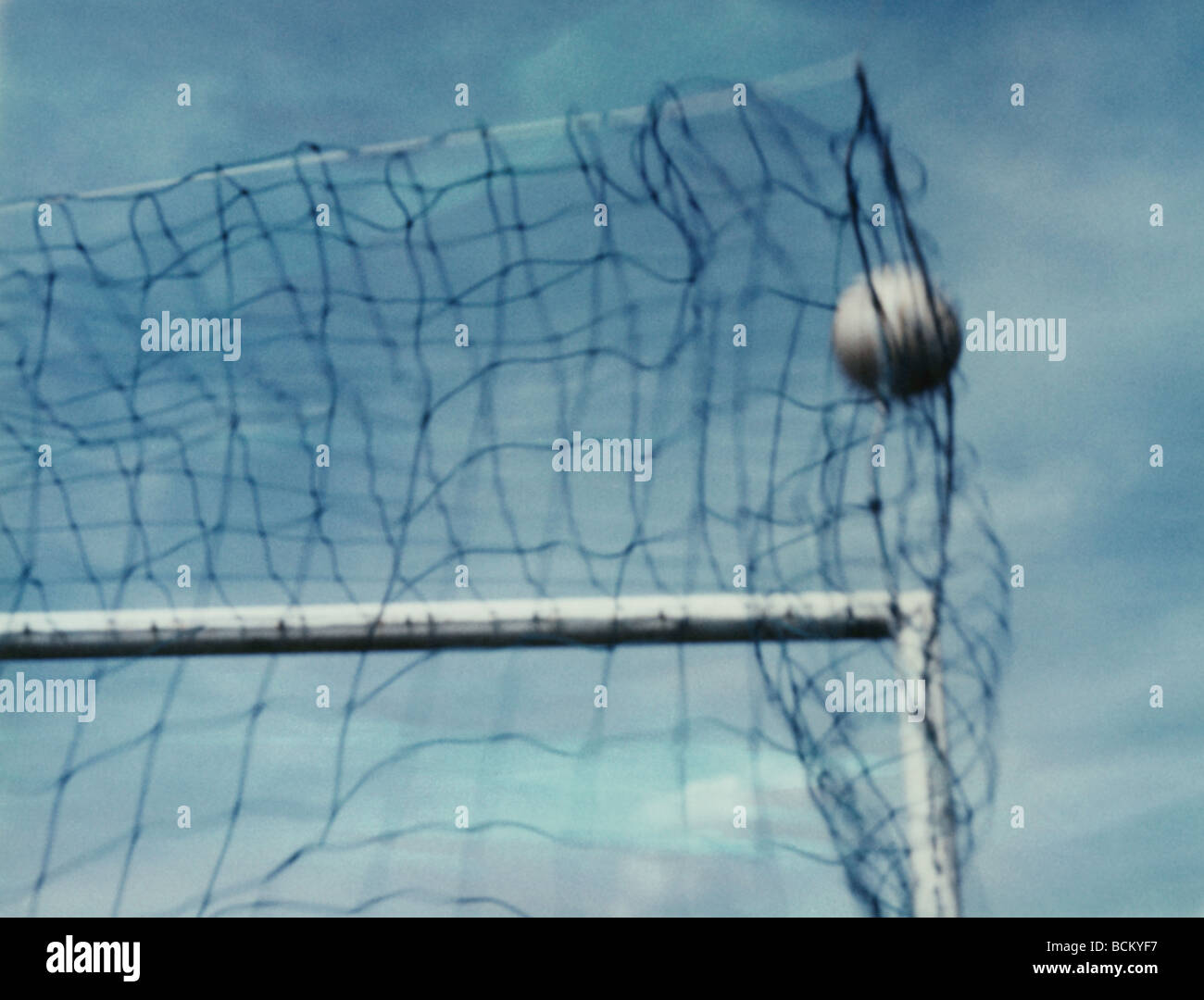 Soccer ball in goal net Stock Photo - Alamy