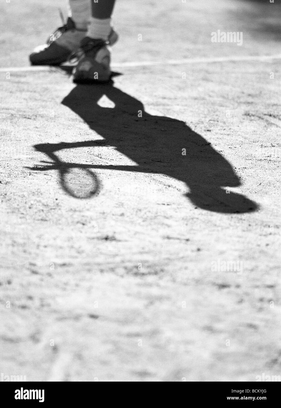 Tennis player and shadow on a tennis court Black and White Stock Photos ...