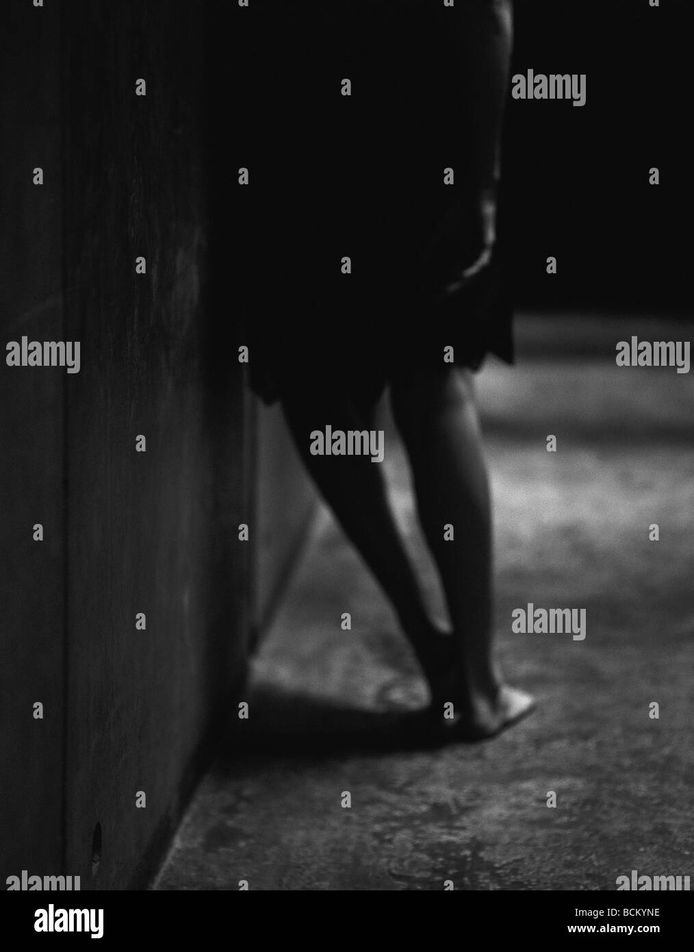 Young Woman Standing Barefoot In Hallway Leaning Against Wall Waist