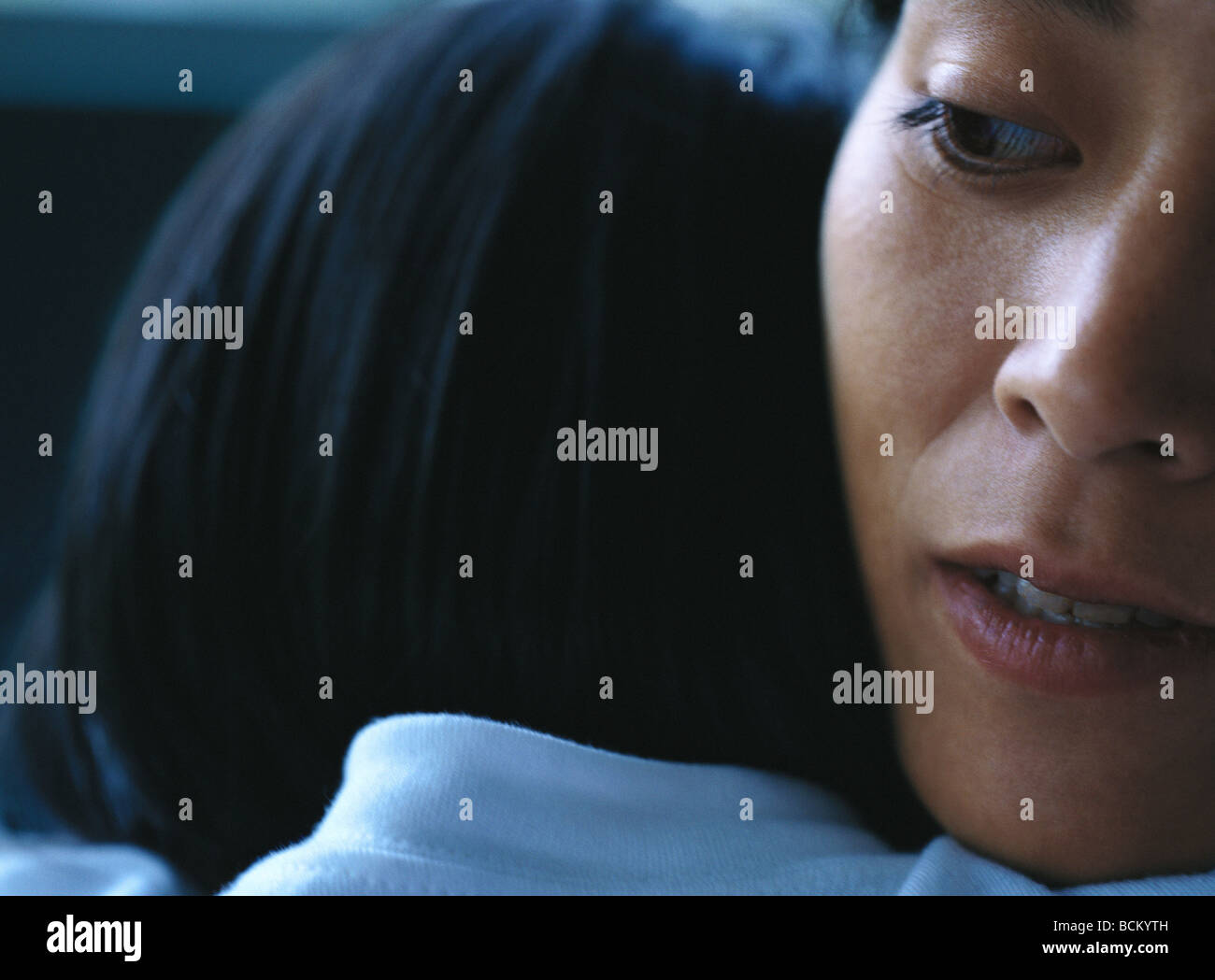 Child resting head on mother's shoulder Stock Photo - Alamy