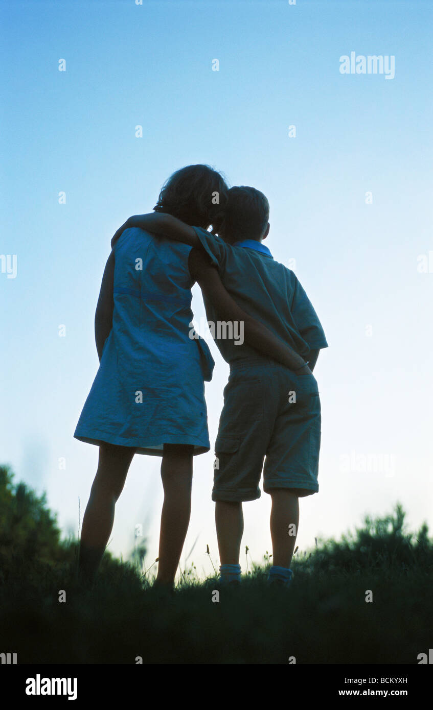 Two boys with arms around each other hi-res stock photography and ...