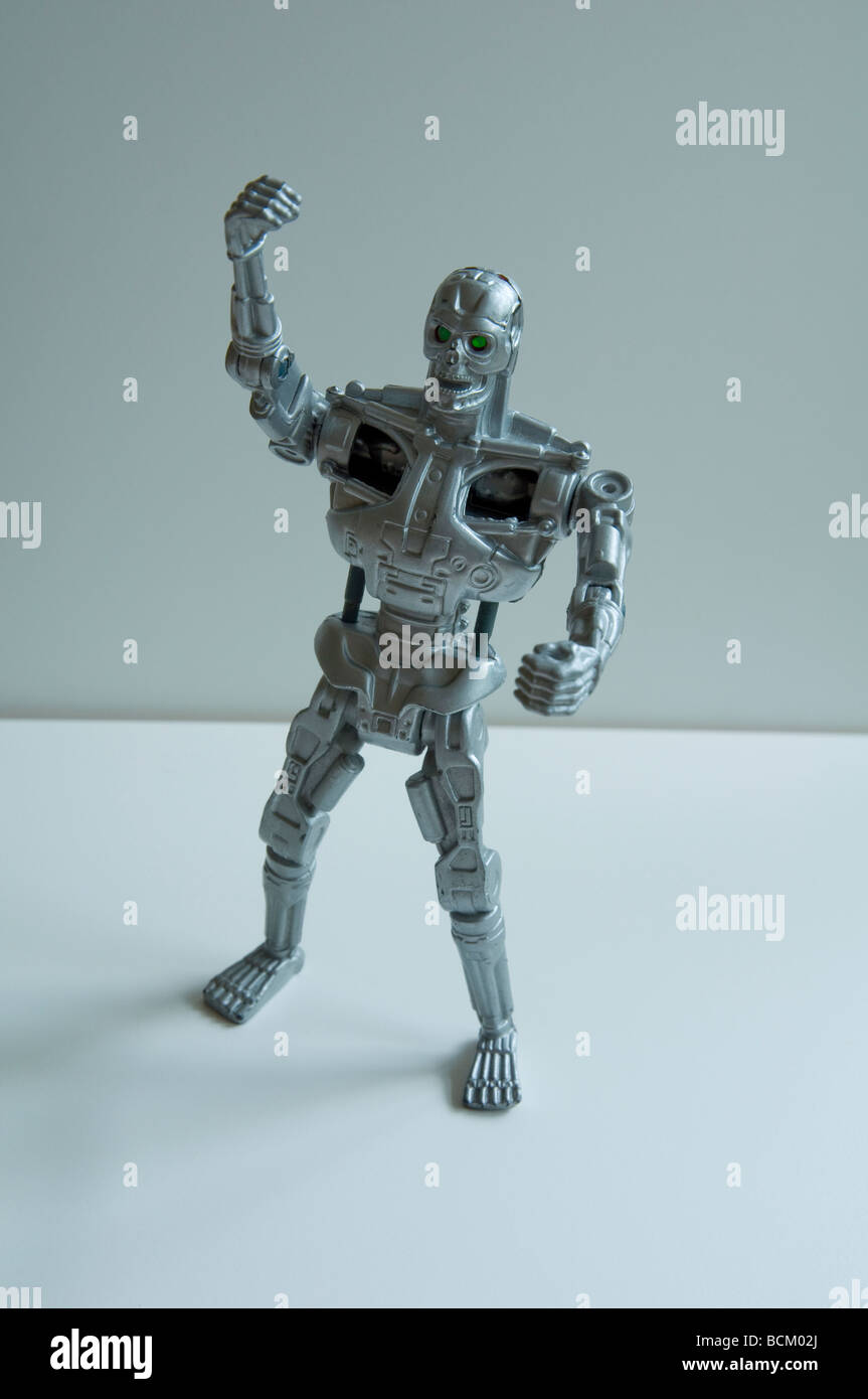 A robot mechanical man looking angry with raised fist and bright green ...