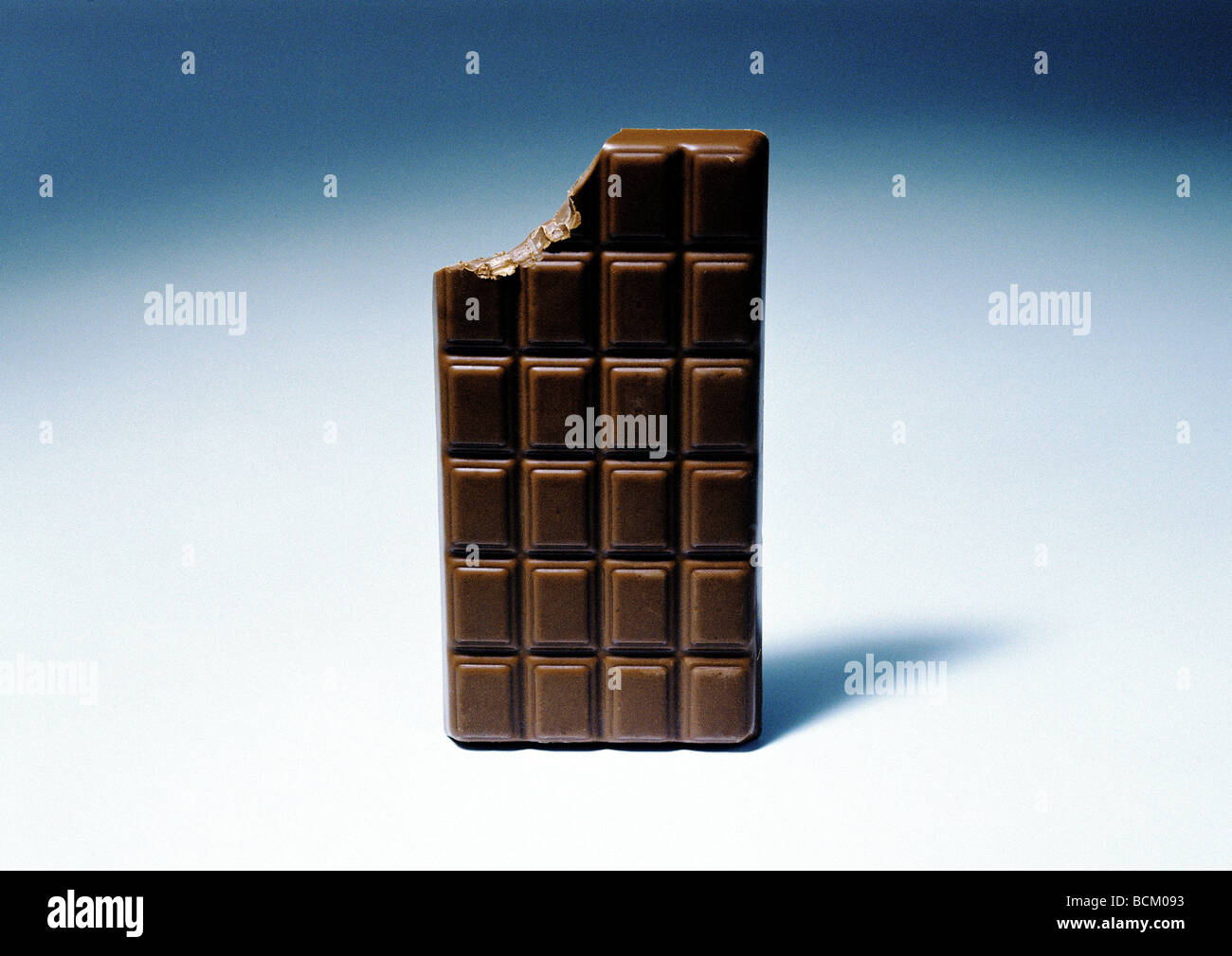 Chocolate bar with bite missing Stock Photo - Alamy